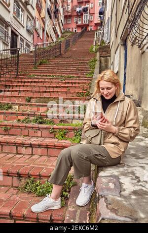 Young middle east woman holding colored pencils smiling happy pointing ...