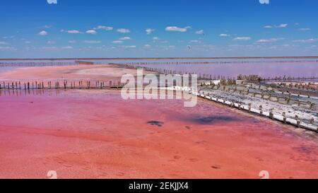 Aerial view of wooden structures for collecting salt on a pink lake ...
