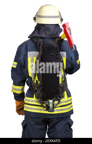 serious firefighter in uniform and helmet checking fire alarm Stock ...