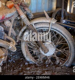 Old rusted abandoned motorcycle in desolate barn Stock Photo - Alamy