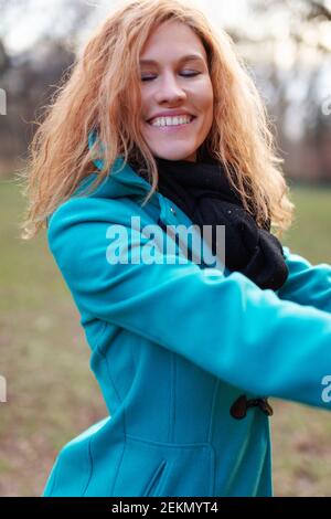 Redhead woman with eyes closed enjoying sunlight Stock Photo - Alamy