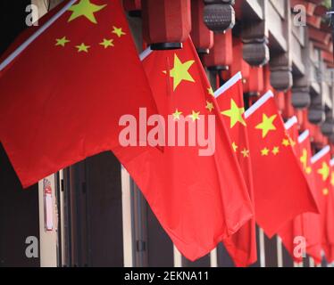 A line of Chinese national flags fly on the street prior to the ...