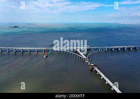 An aerial view of workers building the Zhoudai Bridge, which connect ...