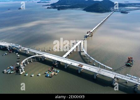 An aerial view of workers building the Zhoudai Bridge, which connect ...