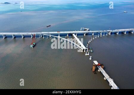 An aerial view of workers building the Zhoudai Bridge, which connect ...