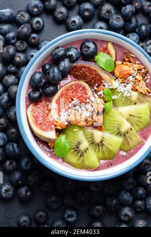 Acai bowl on the blue wooden table Stock Photo - Alamy