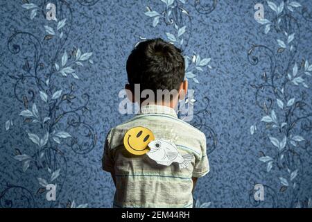 April fools day jokes. A boy in a funny foolish mask holds a big smile ...