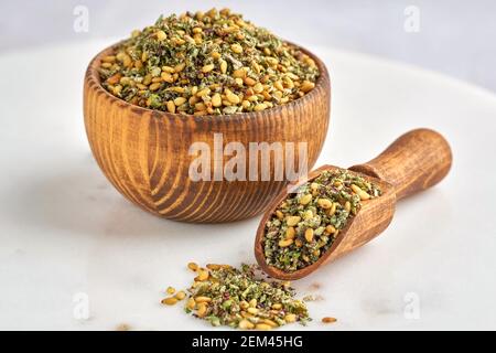Mixed zaatar or zatar spices in white bowl close up. Oriental herbal ...