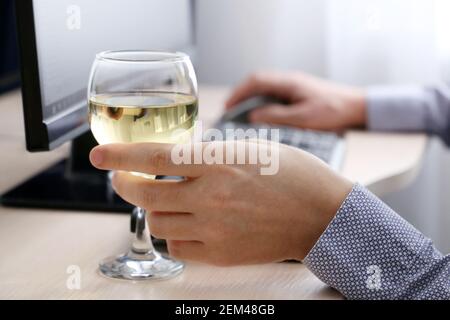 Drunk man sitting at home with computer looking depressed. alcohol ...