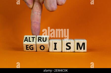 Altruism or egoism symbol. Businessman turns wooden cubes and changes ...