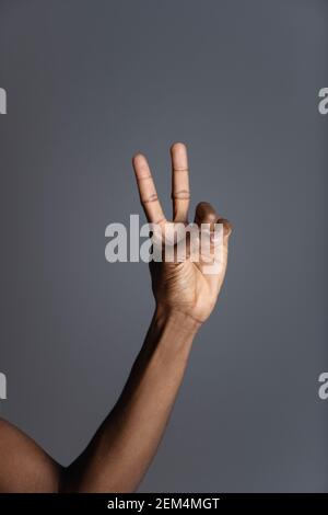 Hand making a gesture on a black smoky background Stock Photo - Alamy