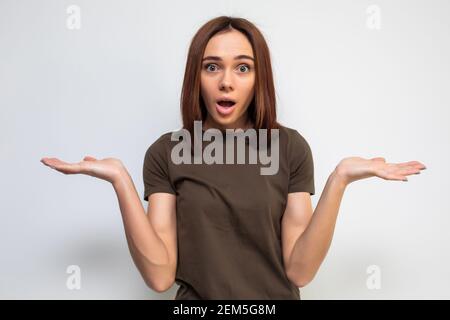 unsure woman with shrug and hands out gesturing uncertainty Stock Photo ...