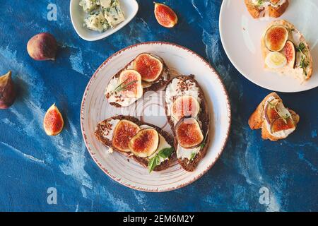 Tasty sandwiches with fig on color background Stock Photo - Alamy