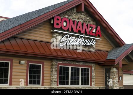 A logo sign outside of a Bonanza Steakhouse restaurant location in ...