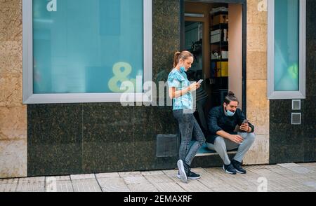 Waitress and cook pausing at the back door Stock Photo - Alamy