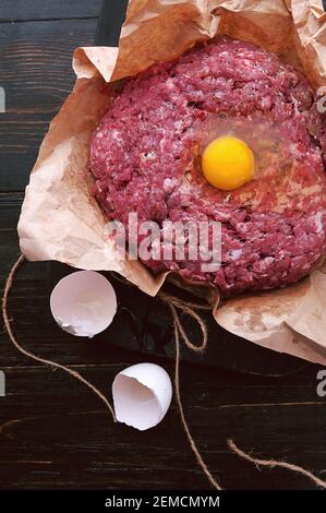 ground beef in a paper bag with a raw egg Stock Photo - Alamy