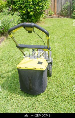 Lawn mower on green grass with copy space for text. Garden work concept ...