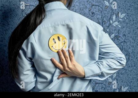 April fools day jokes. A smile and fish stickers on the female back. 1 ...