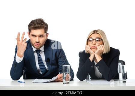 discouraged broadcaster gesturing near upset colleague isolated on ...
