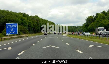 Keep apart 2 chevrons motorway road markings and traffic on M56 ...