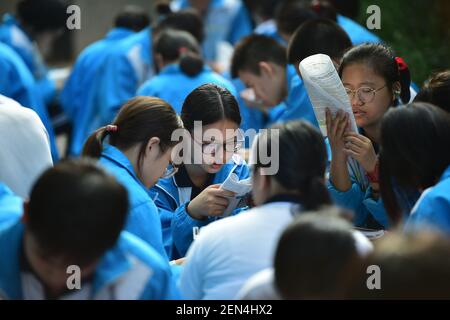 Young Chinese student examinees make final reviews of textbooks before ...