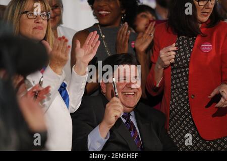 Illinois Gov. J.B. Pritzker, left, greets the Rev. Jesse Jackson Sr ...