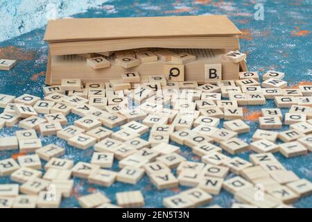 Wooden dice with printed letters on them on blue background Stock Photo ...