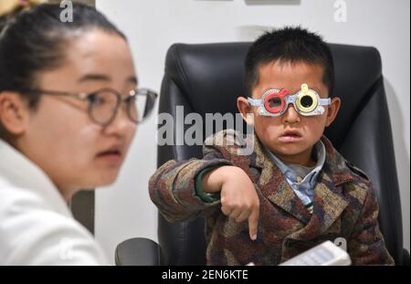 --FILE--A near-sighted young Chinese boy student attends a lecture ...