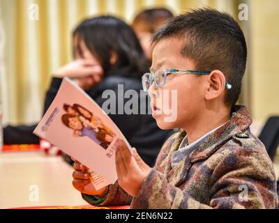 --FILE--A near-sighted young Chinese boy student attends a lecture ...