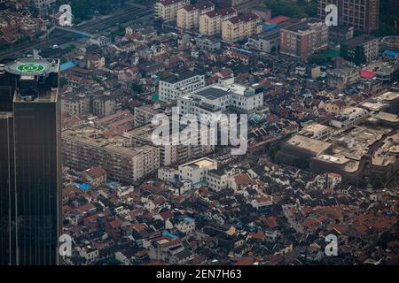 Residential houses in longtang are embraced by skyscrapers and high ...
