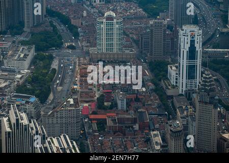 Residential houses in longtang are embraced by skyscrapers and high ...