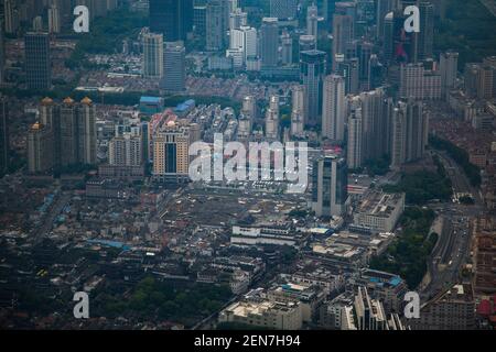 Residential houses in longtang are embraced by skyscrapers and high ...