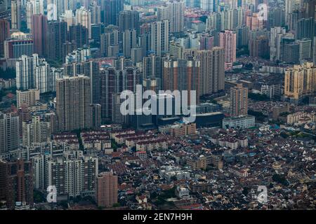 Residential houses in longtang are embraced by skyscrapers and high ...