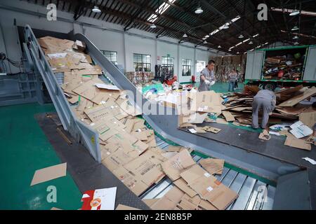 A Chinese worker sorts out recycling waste at a distribution center of ...