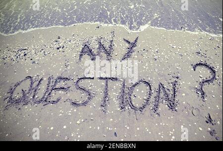 big text any question written in the sand of the beach by the sea Stock ...