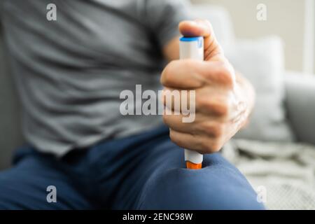 Auto Epinephrine Injector. Patient Doing Leg Injection Stock Photo - Alamy