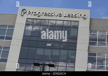 A logo sign outside of the headquarters of Progressive Leasing in ...