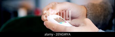 Blood glucose meter in hand on blue background close up Stock Photo - Alamy