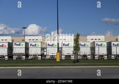 FedEx Ground logos on truck trailers at a FedEx distribution center in ...