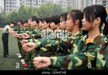 Chinese freshmen students exercise during a military training session ...