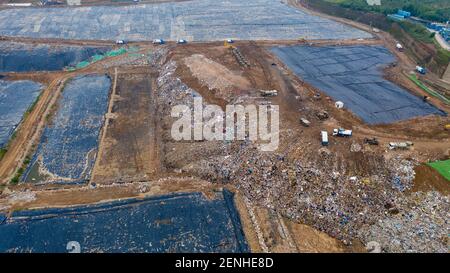 Chinese workers sort out and bury kitchen waste at the Jiangcungou ...
