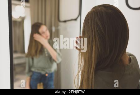 Tween girl standing in fitting room in clothing store Stock Photo - Alamy