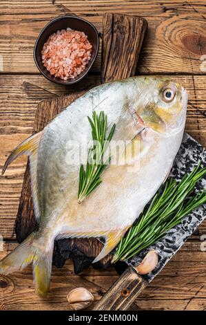 Raw fish Sunfish or pompano on a wooden board. wooden background. Top ...