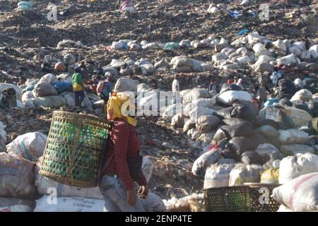 Scavengers sort and collect plastics for recycling at the garbage ...