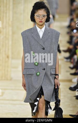 Model Yilan Hua walking on the runway during the Miu Miu Ready to Wear ...