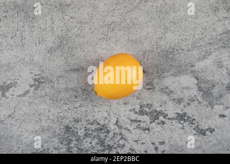 Single fresh yellow lemon placed on stone surface Stock Photo - Alamy