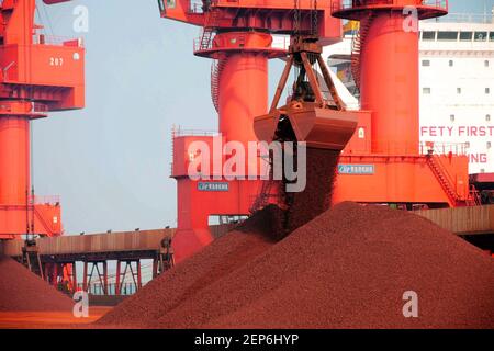 Shandong,CHINA-Cargo ships unload imported iron ore at Dongjiakou port ...