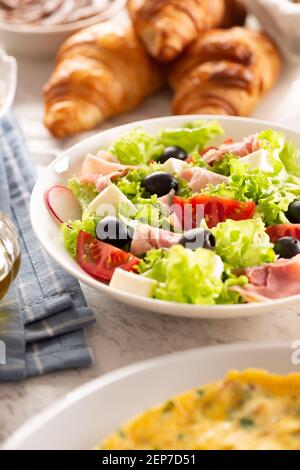 Fresh salad served in a bowl at a buffet location Stock Photo - Alamy