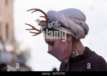 A religious Jewish woman with reindeer antlers wears face mask due to ...