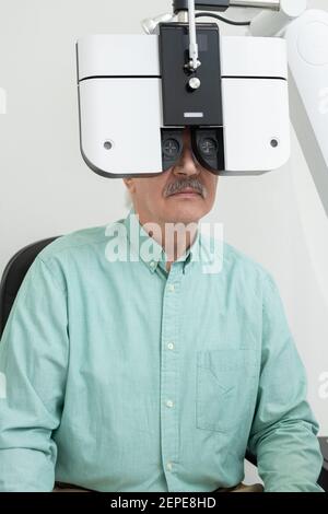 Senior businessman with virtual reality simulator holding light bulb ...